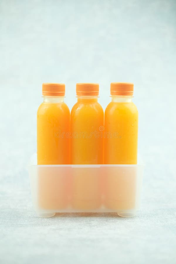 Three Plastic Bottles with Orange Juice in Box Stock Photo - Image of ...