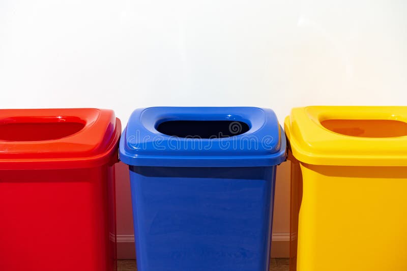Three Plastic Trash Bins Against the Wall in the Building Stock Image ...
