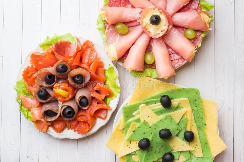 Three Plates of Appetizers. Ham Roll with Cheese and Red Fish, Slicing ...