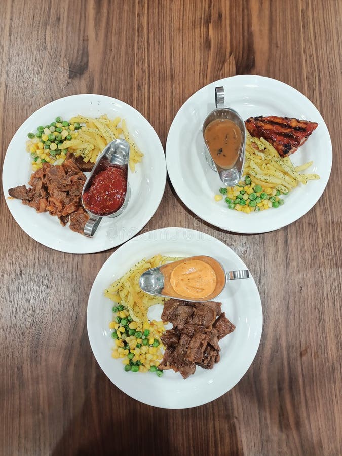 Three plates of steak stock photo. Image of three, meal - 265230816