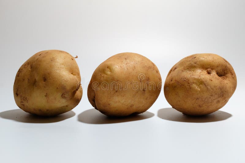 Three Potatoes on a White Background Stock Photo - Image of close ...
