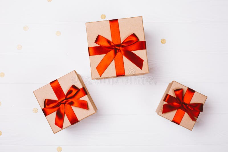 Three Present Boxes with Red Bow on Wooden Background. Stock Image ...