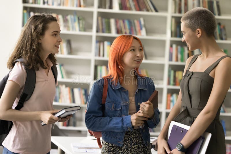 Three Pretty Female Students Talking Met in Library Stock Photo - Image ...