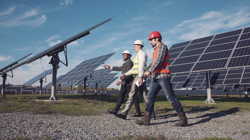Three Professionals in Solar Power Station. Stock Photo - Image of ...