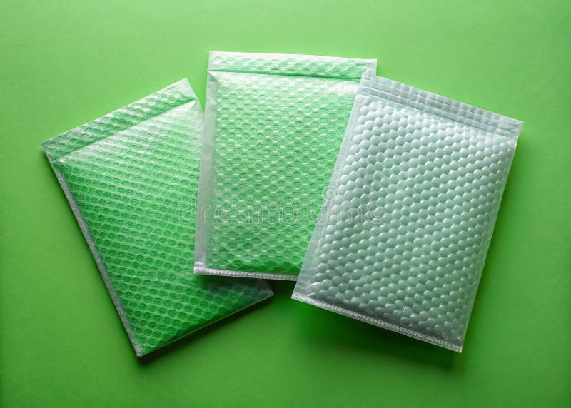 Three Protective Envelopes with Bubble Wrap on a Vibrant Green ...