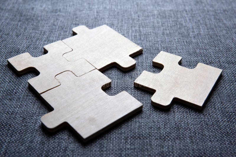 Three Puzzle Pieces in a Row on a Wooden Background Stock Image - Image ...