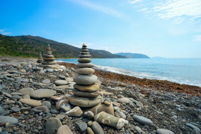 The Three Pyramids of Sea Pebbles on the Beach . Stock Photo - Image of ...