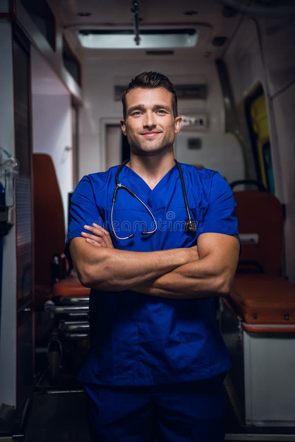 A Three Quarter Portrait of a Young Handsome Paramedic with His Hands ...