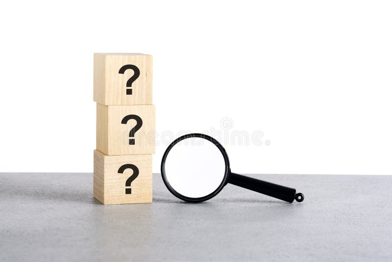 Three Question Sign on Wooden Cube with Magnifying Glass on Grey Table ...