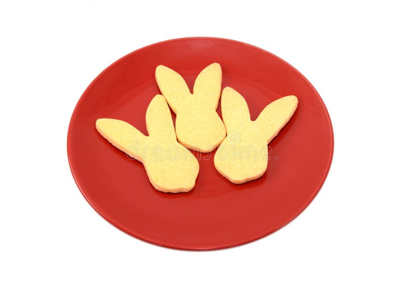Three Rabbit-shaped Cookies for Easter on a Red Plate Stock Photo ...