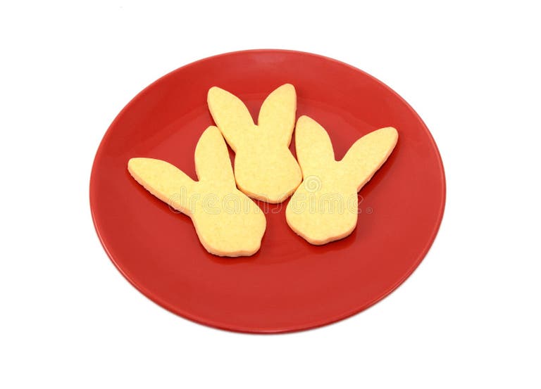 Three Rabbit-shaped Cookies for Easter on a Red Plate Stock Photo ...
