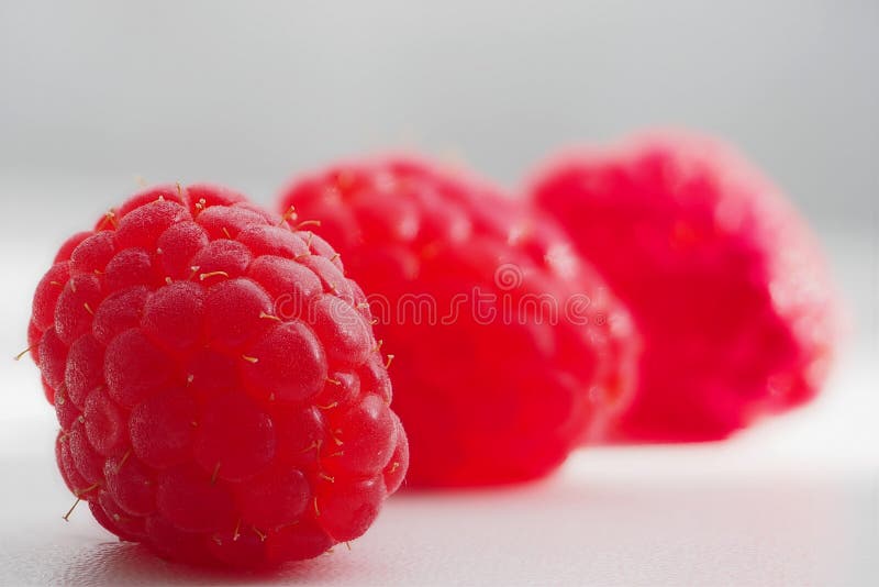Three Raspberries in a Row, Focus on the First, Three Red-pink ...
