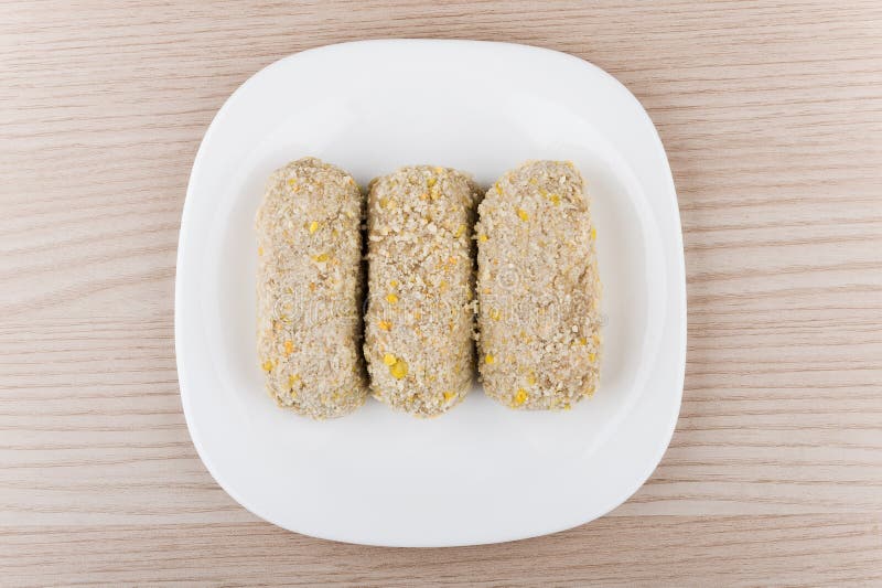 Three Raw Cutlets in Glass Plate on Wooden Table Stock Image - Image of ...