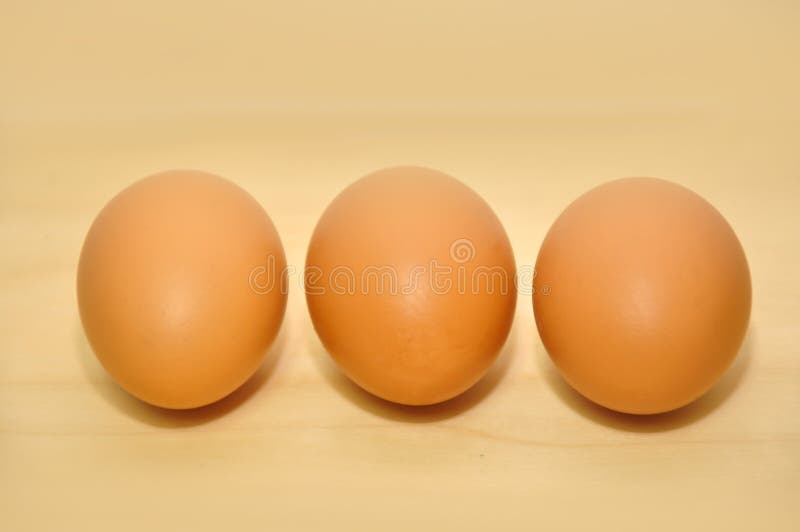 Three raw egg in a row stock photo. Image of diet, group - 87522608