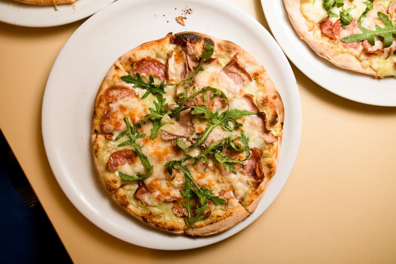 Three Ready-made Mini Pizzas with Jamon,ruccola Covered with Cheese on ...