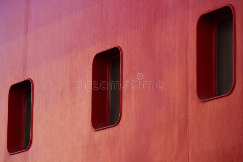 Three Rectangular Portholes on a Red Ship Hull Stock Photo - Image of ...