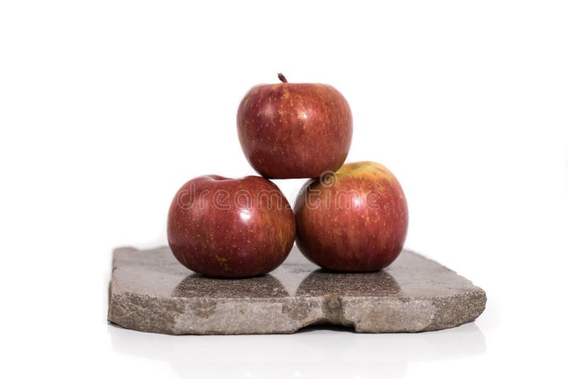 Three Red Apples Arranged in a Pyramid on a Rectangular, Rough-edged ...