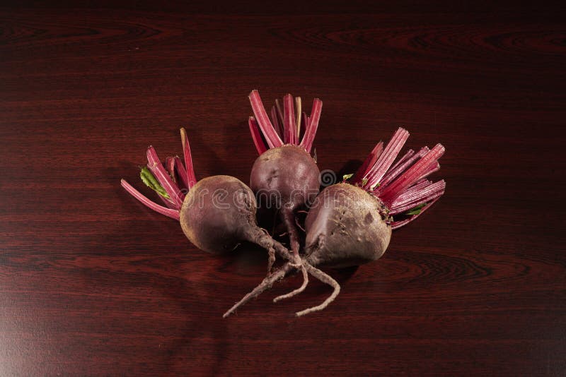 Three red beets on a table stock photo. Image of purple - 73945952