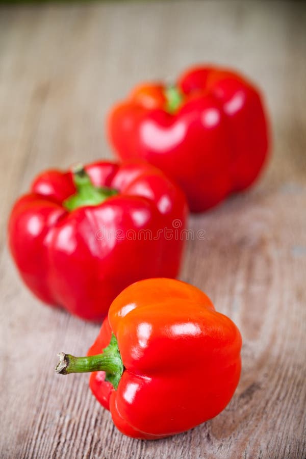 Three red bell peppers stock image. Image of wood, organic - 26605489
