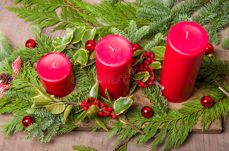 Three Red Candles in a Christmas Arrangement Stock Image - Image of ...