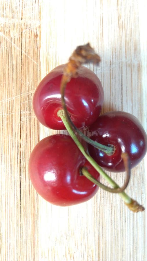 Three Red Cherry on the Table Stock Photo - Image of orange, dish ...