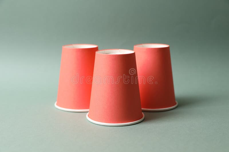 Three Red Cups on Pale Olive Background. Thimblerig Game Stock Image ...