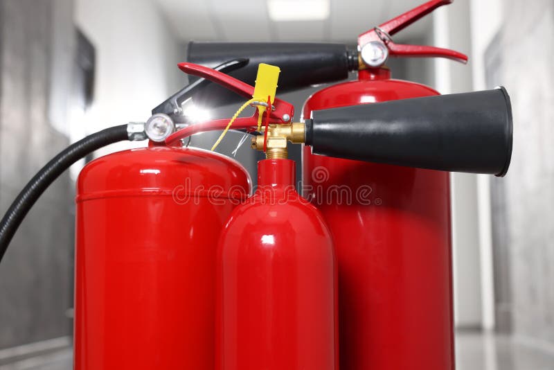 Three Red Fire Extinguishers in Hall, Closeup Stock Photo - Image of ...