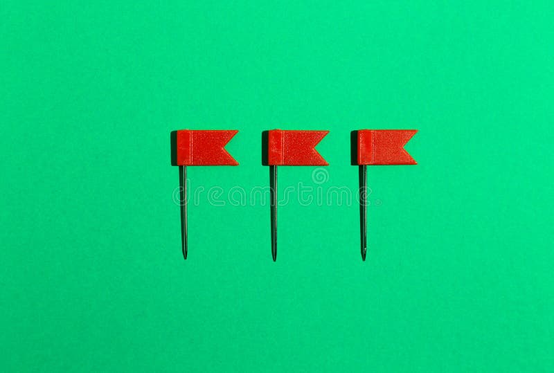 Three Red Little Flag Pins on a Green Background. View from Above Stock ...