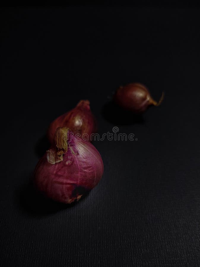 Three Red Onions on a Black Background Stock Photo - Image of onion ...