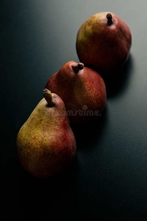 Three Red Pears on a Black Table Stock Photo - Image of fresh, organic ...