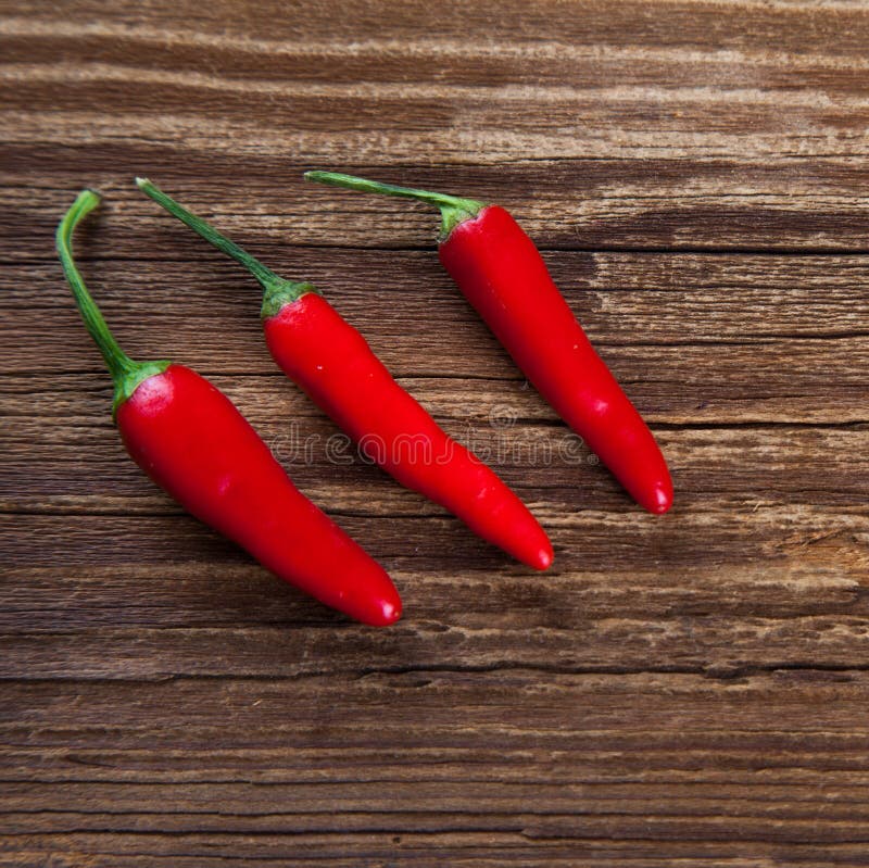 Three Red Pepperoni on Wood Stock Photo - Image of spice, decorative ...