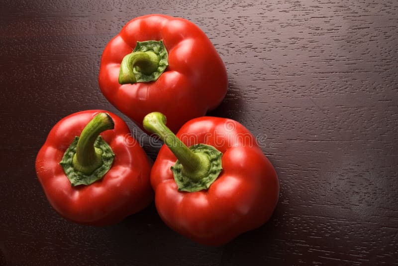Three Red Peppers on Dark Wood Stock Image - Image of vegetable, wood ...