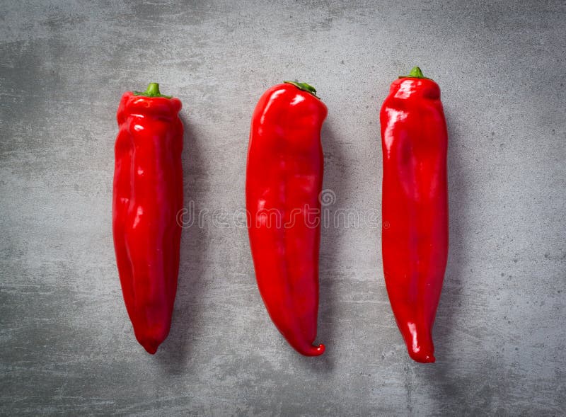 Three red peppers on a row stock image. Image of spicy - 70613597