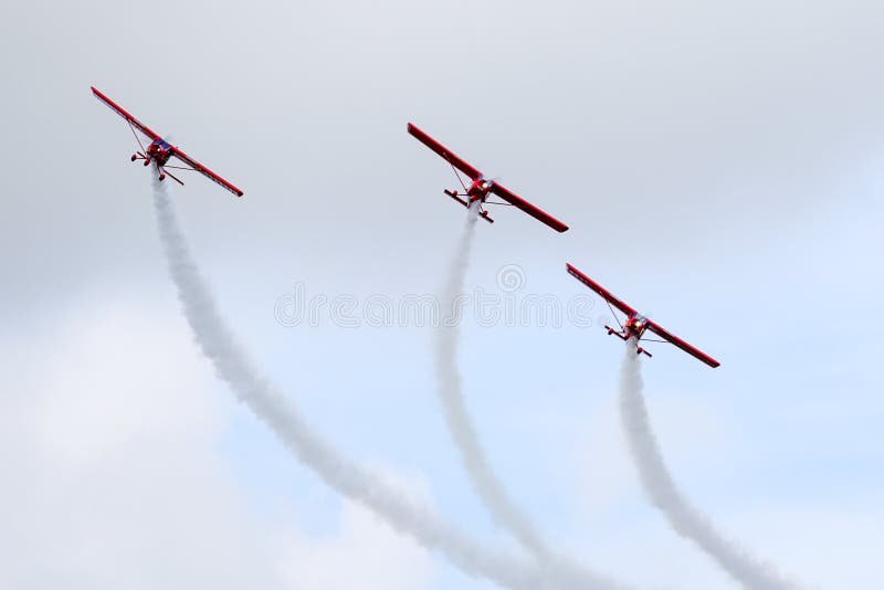 Three Red Sports Planes Make a Parallel Flight during an Air Show Stock ...