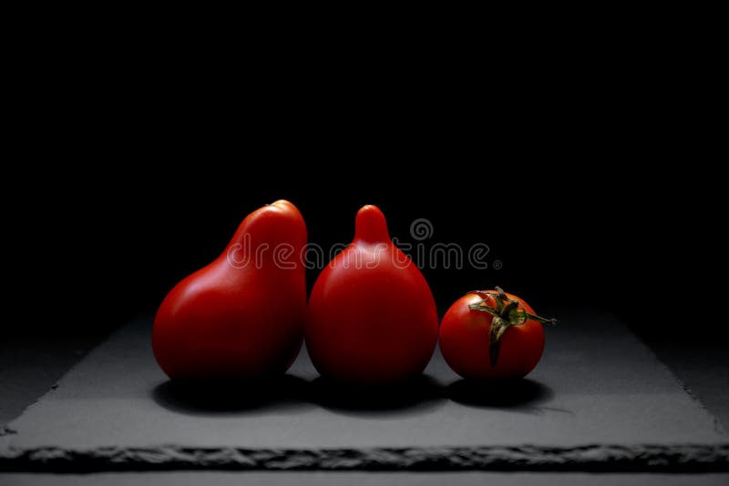 Three Red Tomatoes on a Black Background. Tomato Isolated, Side View ...