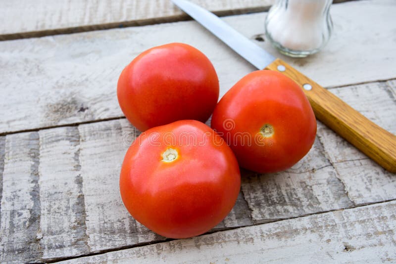 Three red tomatoes stock image. Image of table, three - 161432871