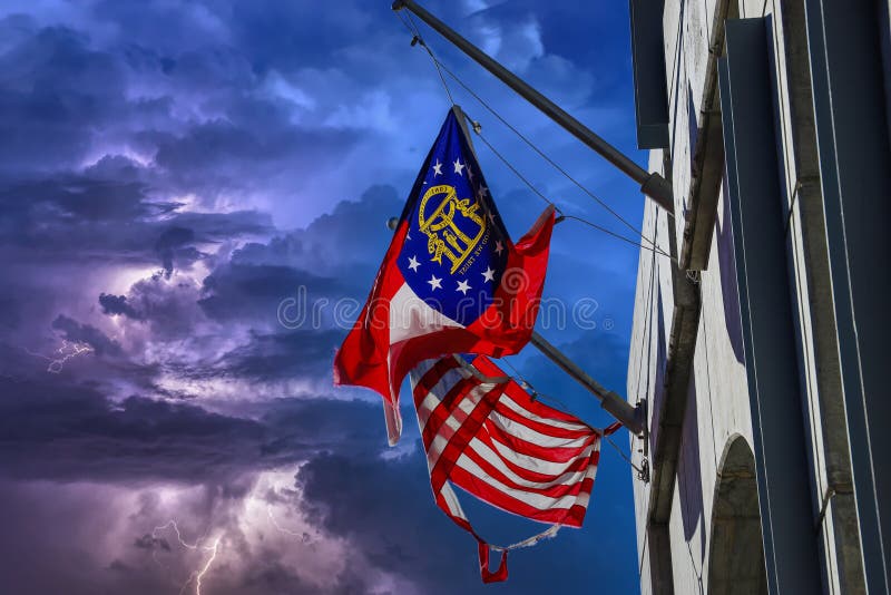 Three Red, White and Blue Flags Flying on a Concrete Hotel with a Tall ...