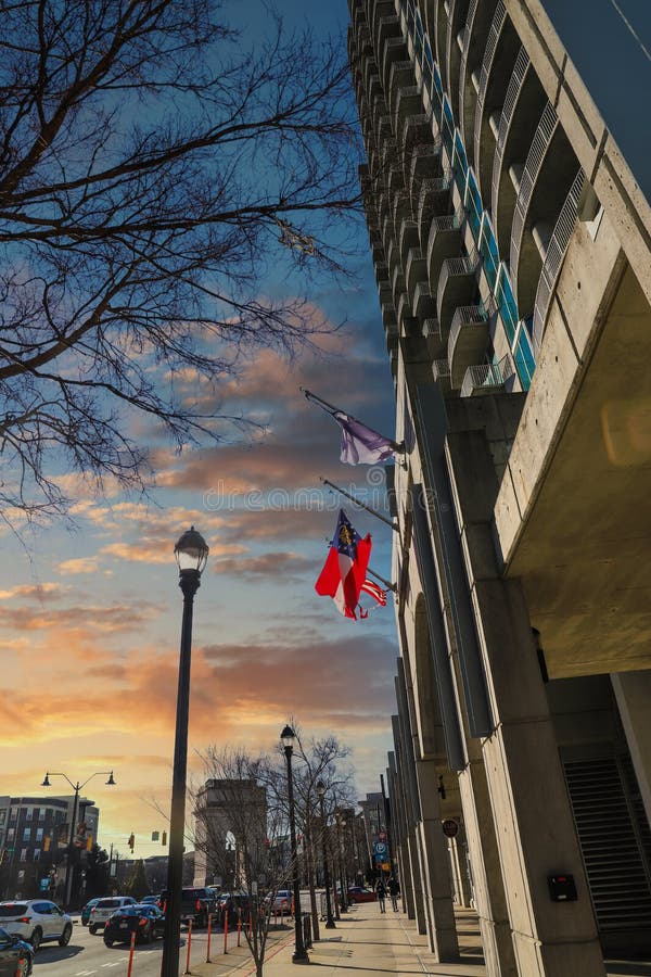 Three Red, White and Blue Flags Flying on a Concrete Hotel with a Tall ...