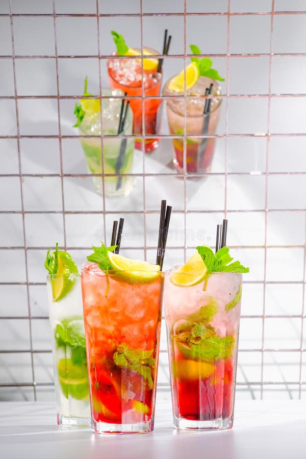 Three Refreshing Summer Cocktails in Glasses with Tubes on the Bar Rack ...
