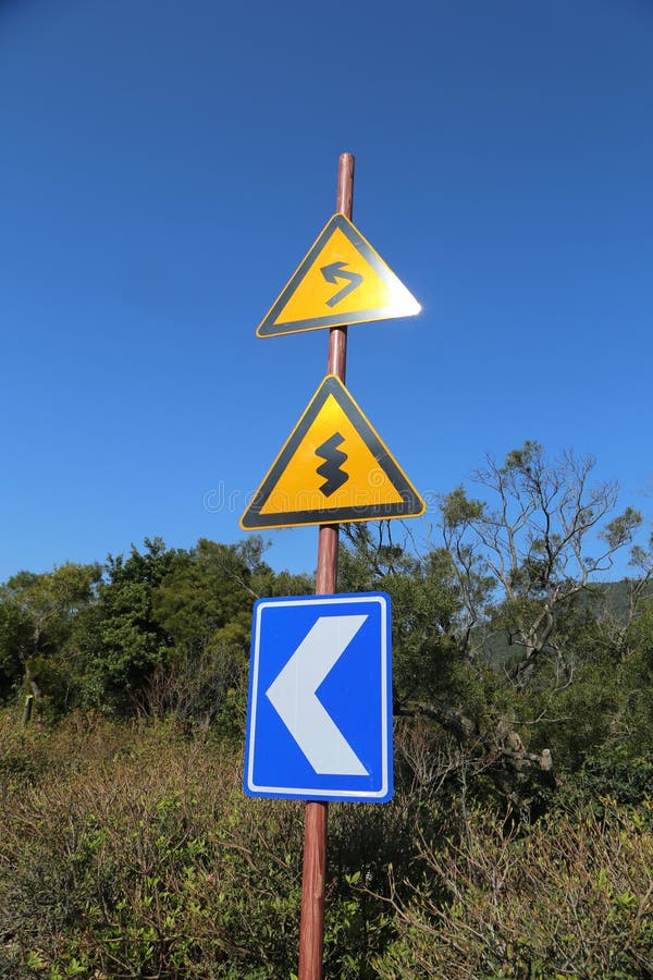 Three Road Signs on a Single Pole: a Blue Square Sign with an Arrow ...