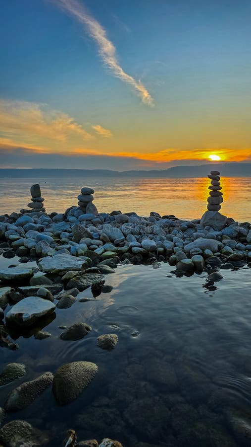 Three Rock Sculptures, Rock Balancing in Sunlight on the Evening Lake ...
