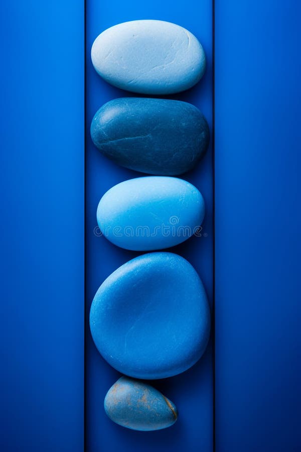 Three Rocks Sitting in Row on Blue Background with White Border ...
