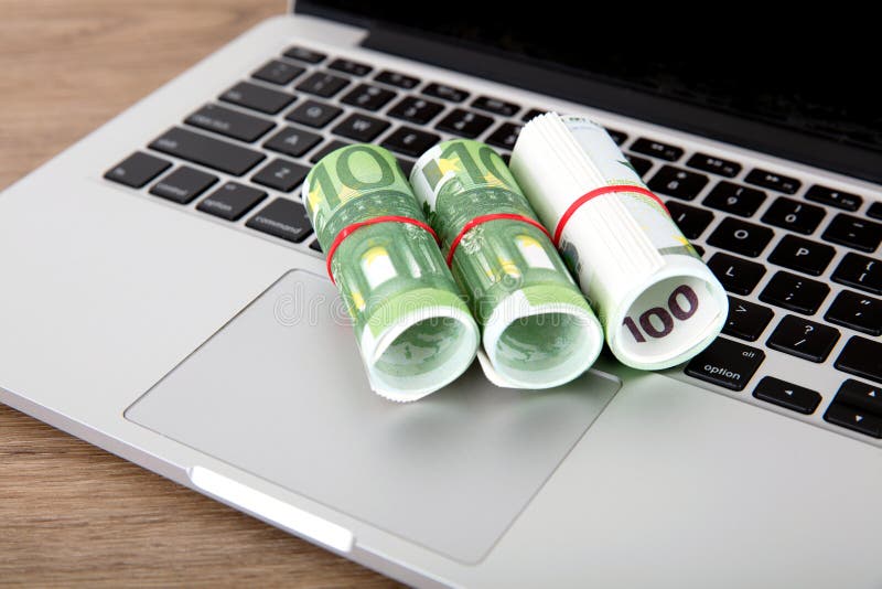 Three Rolls of One Hundred Euro Banknotes on a Computer Keyboard Stock ...