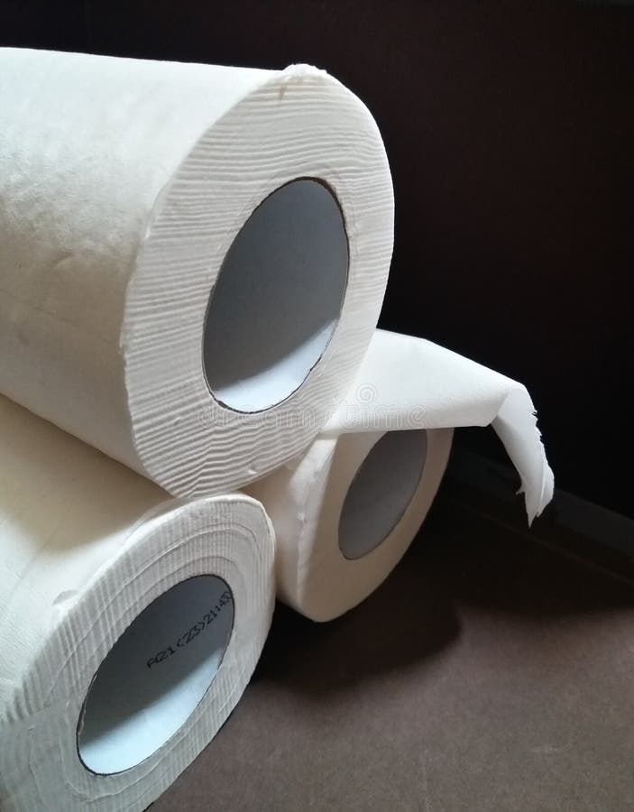 Three rolls of tissue stock image. Image of hand, table - 275508251