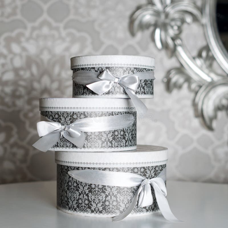 Three Round Celebration Gift Boxes with Silver Ribbon Bows on White ...