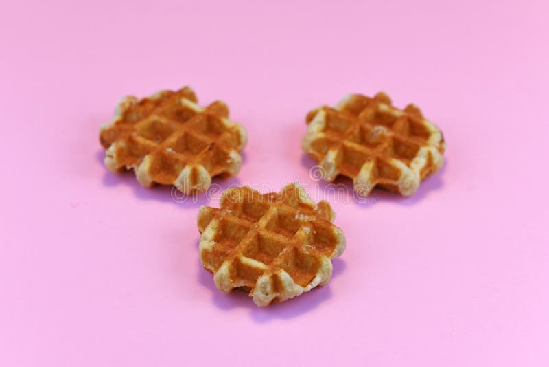 Round Waffles with Sugar Powder on Paper Lace Doily and Pink Ground ...
