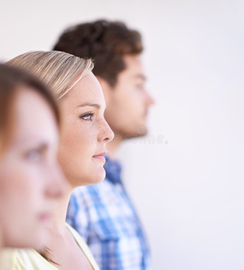 Three in a Row. Closeup Shot of Three Young Adults Standing in a Row ...