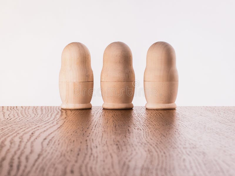 Three Russian Wooden Unpainted Matryoshka Dolls on the Table Stock ...