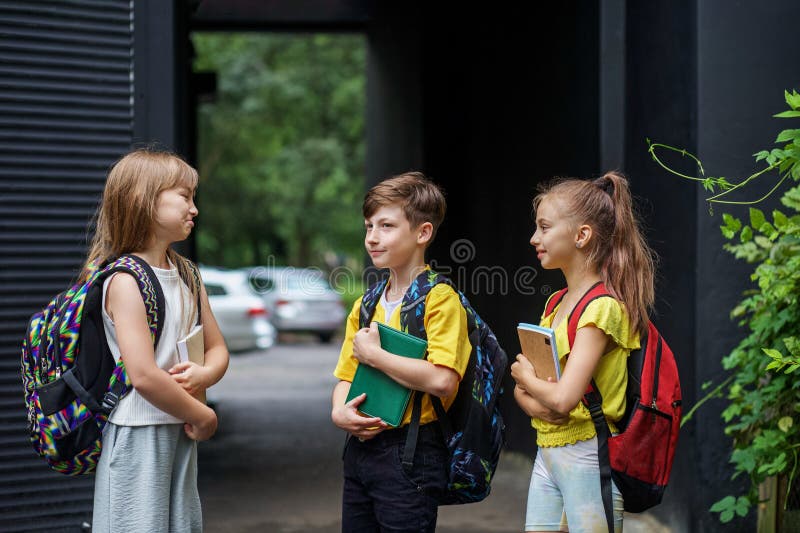 Three School Children Communicate and Having Fun Outdoors. Classmates ...