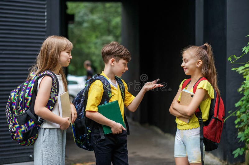 Three School Children Communicate and Having Fun Outdoors. Classmates ...